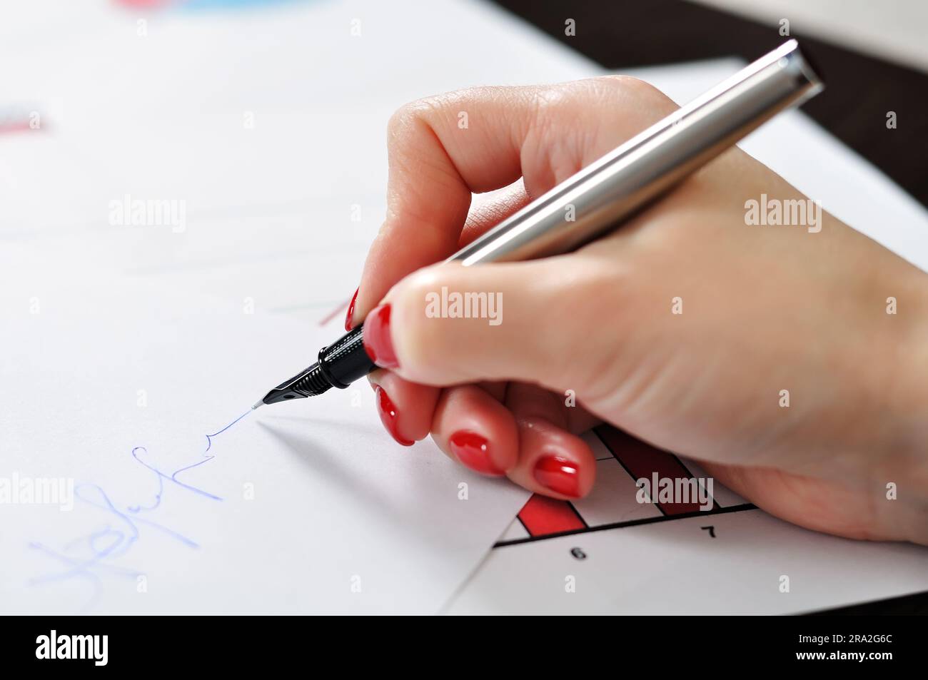hand with a fountain pen on paper signs Stock Photo - Alamy