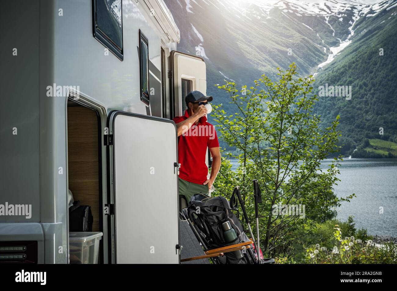 Caucasian RV Owner Drinking Morning Coffee Inside a Camper Van Right ...