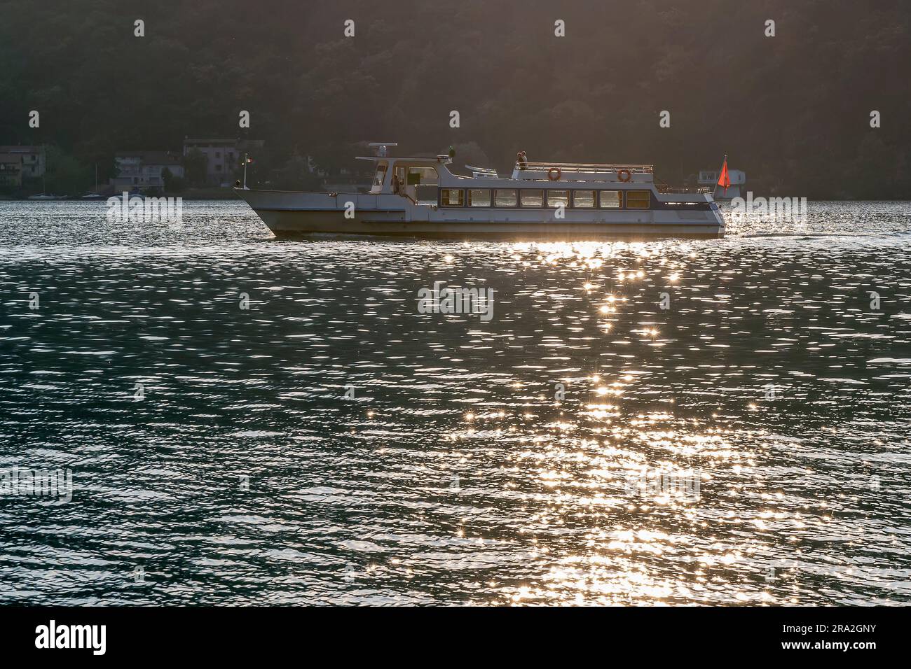 A ferry on Lake Lugano arrives at Porto Ceresio, Italy, from Morcote ...