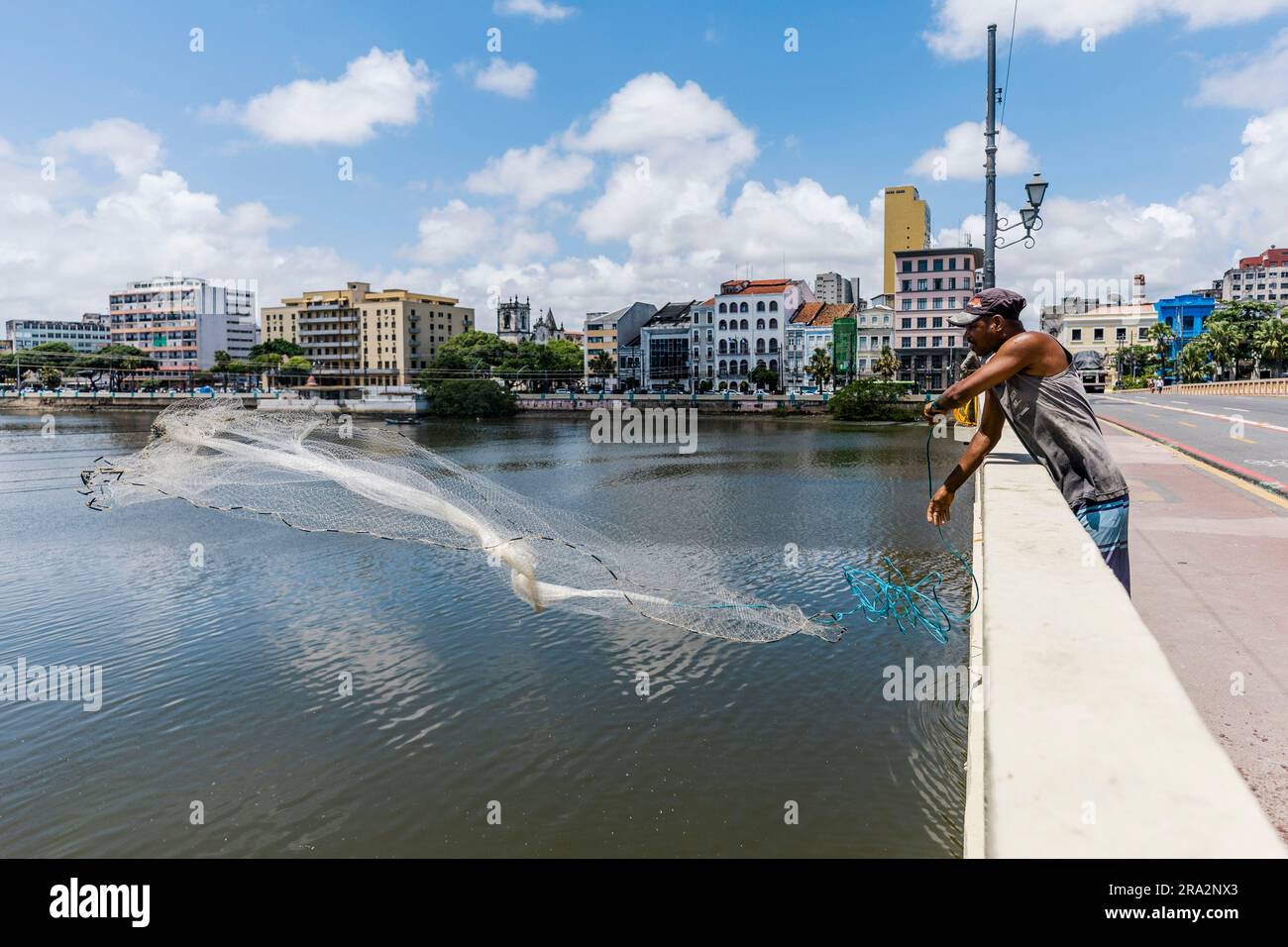 Brazil, Nordeste, Recife, fisherman throwing his net in the water in ...