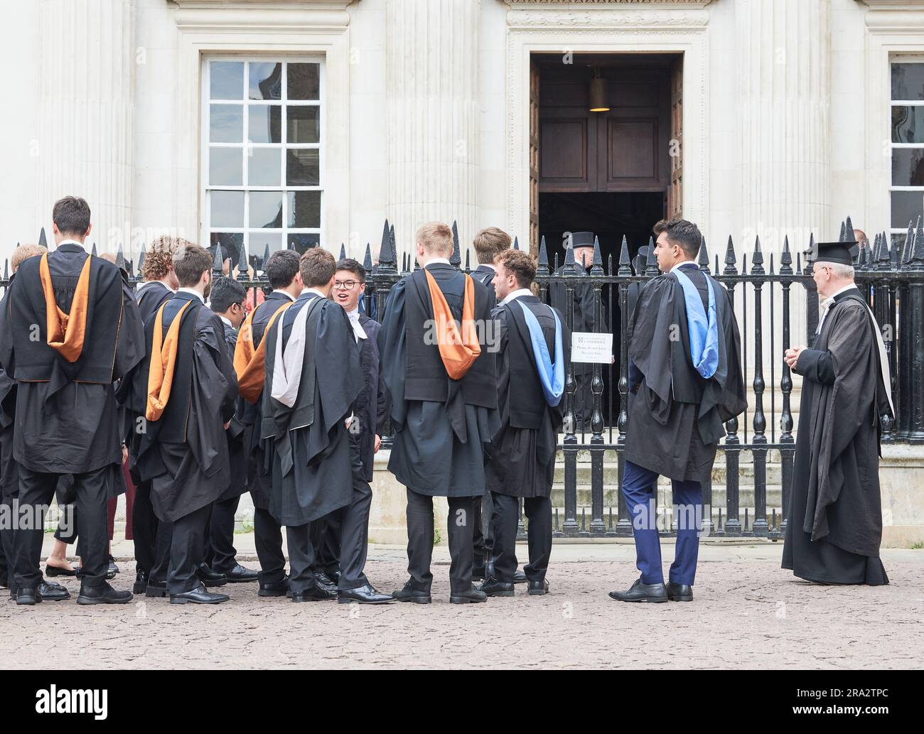 Students from Emmanuel College, University of Cambridge, England, wait ...