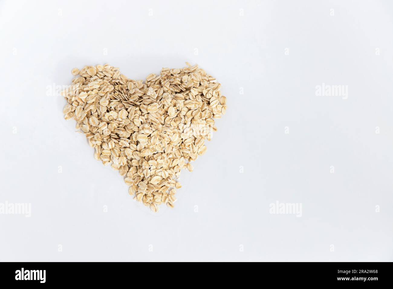 Oat flakes forming a heart on white background, conceptual image. Super ...
