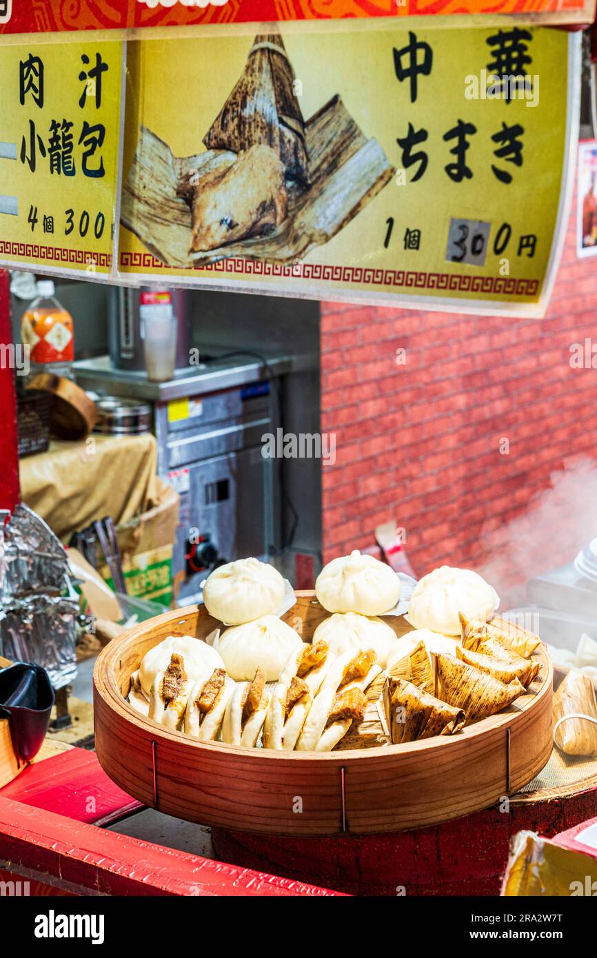 Chinese dumplings and steamed buns cooking in a bamboo bowl on a hot ...