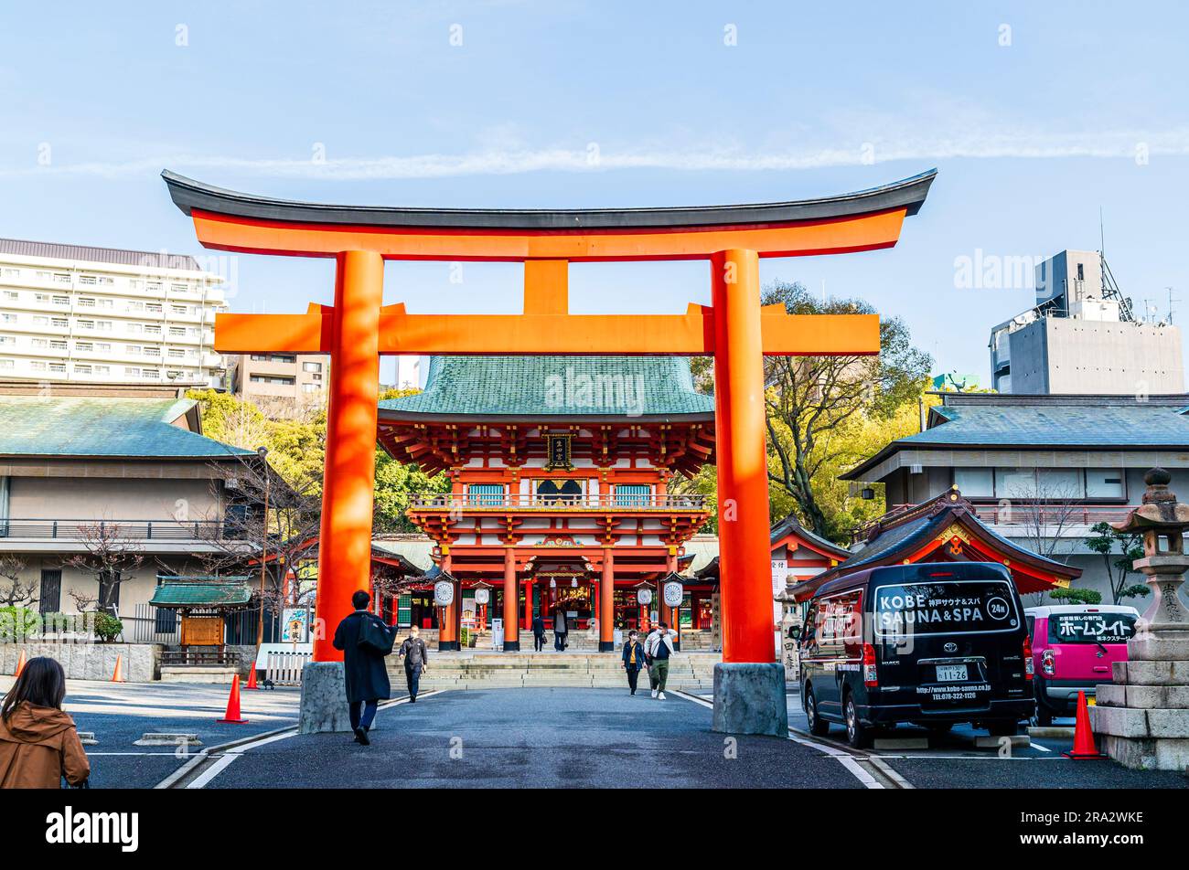 Large vermilion torii gate with the main gateway behind and the Haiden ...