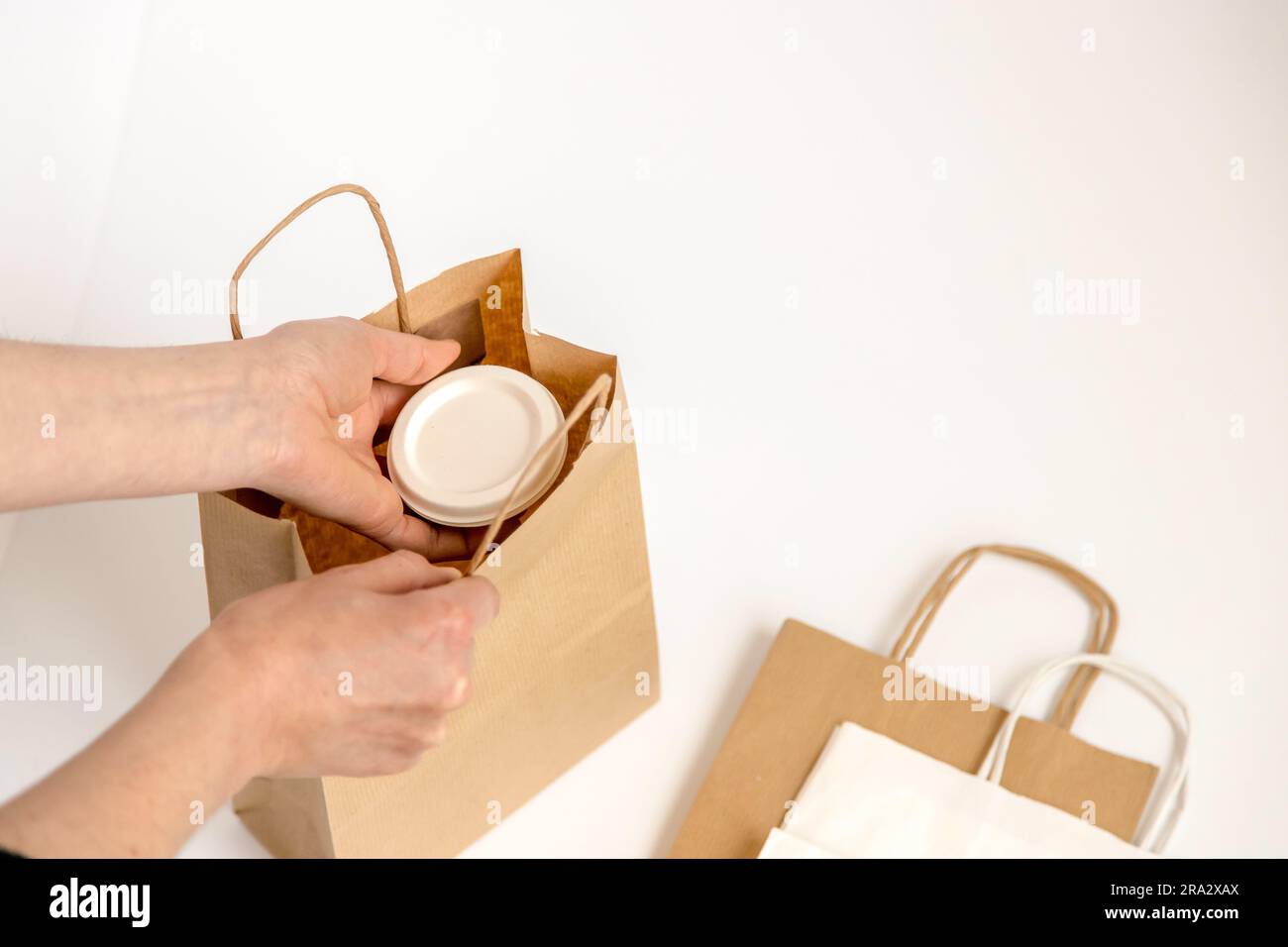 Action, person putting things inside kraft paper bag. Conceptual image ...