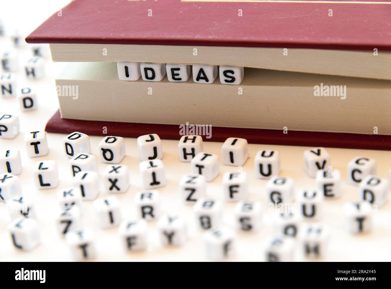 Word ideas written with letters between a book pages white background ...