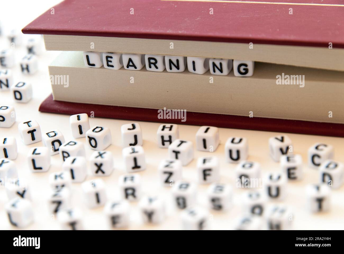 Word learning written with letters between a book pages white ...