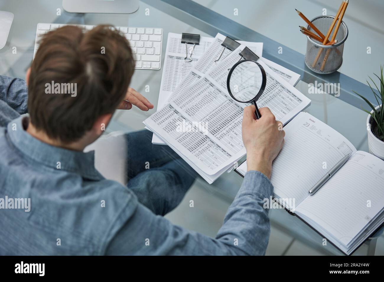 Businessman reading documents magnifier hi-res stock photography and ...