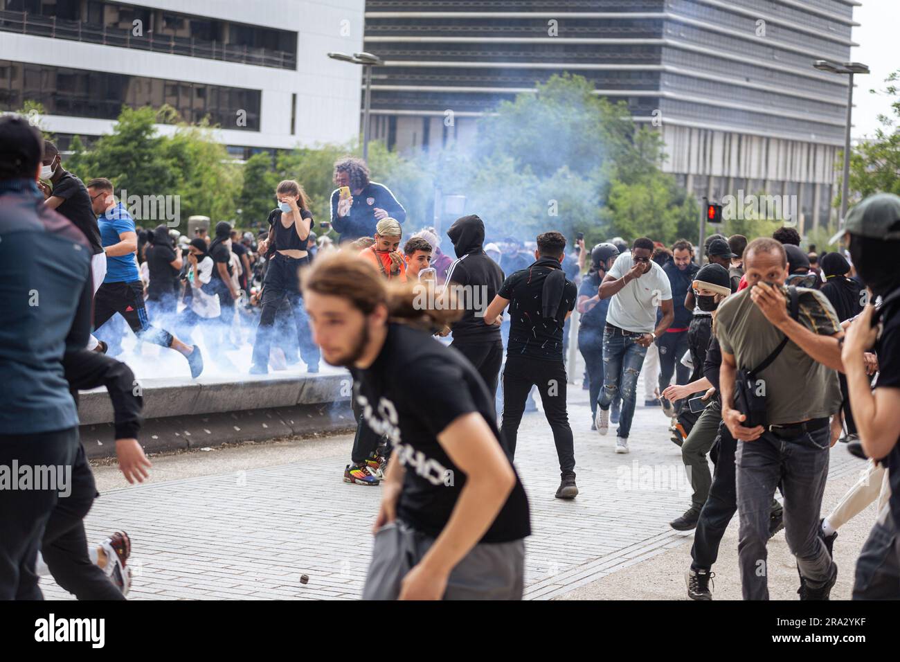 Protesters flee from tear gas launched by the police during the march ...
