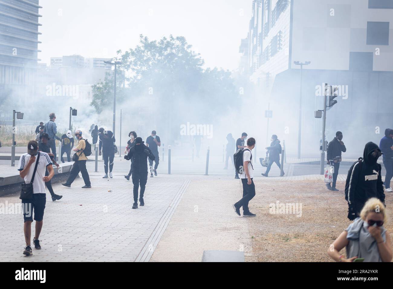 Protesters flee from tear gas launched by the police during the clashes ...