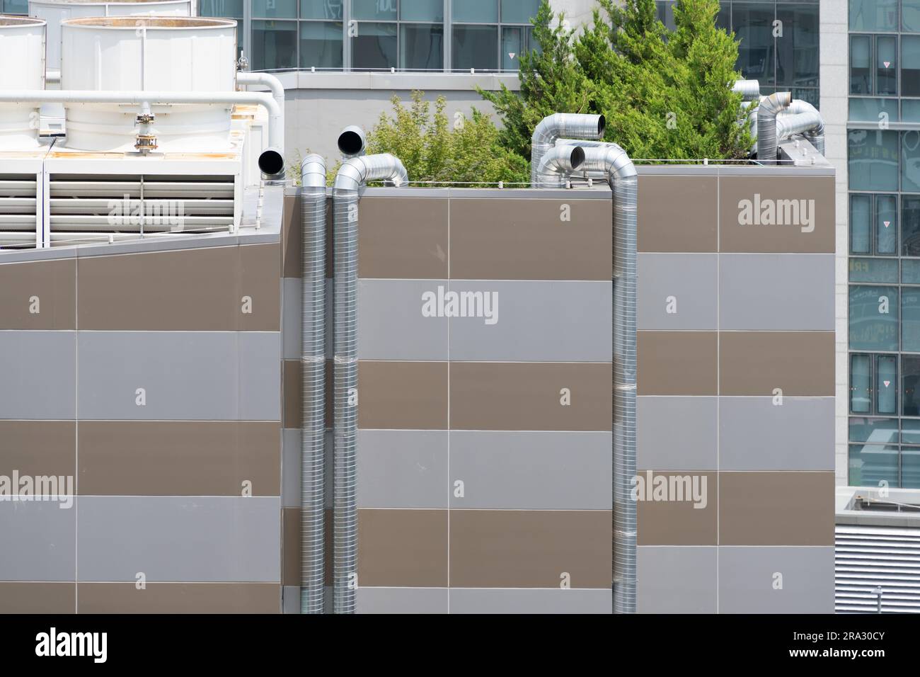 Ventilation tubes that go up to the roof on the outer wall of a high ...