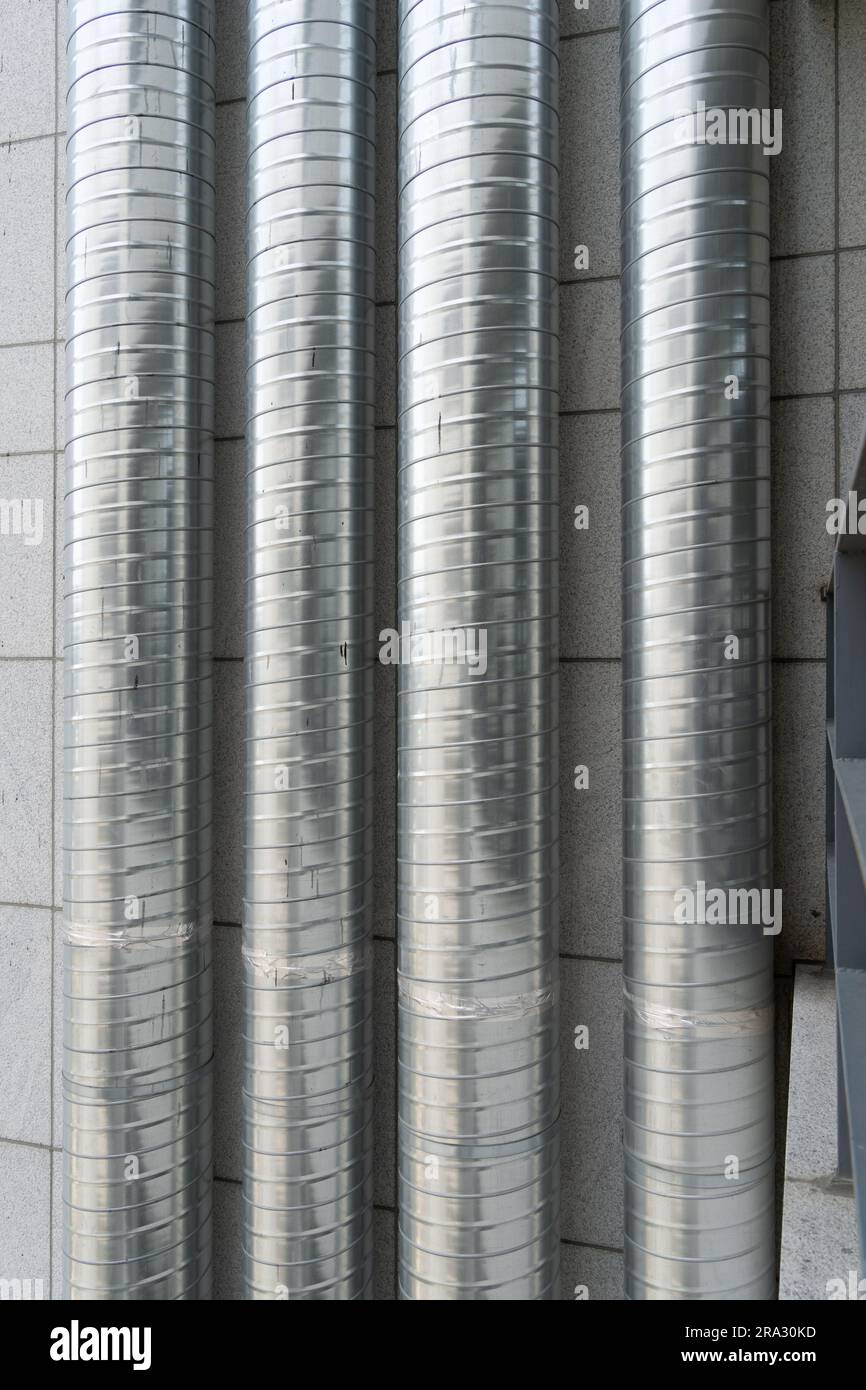 Ventilation tubes that go up to the roof on the outer wall of a high ...