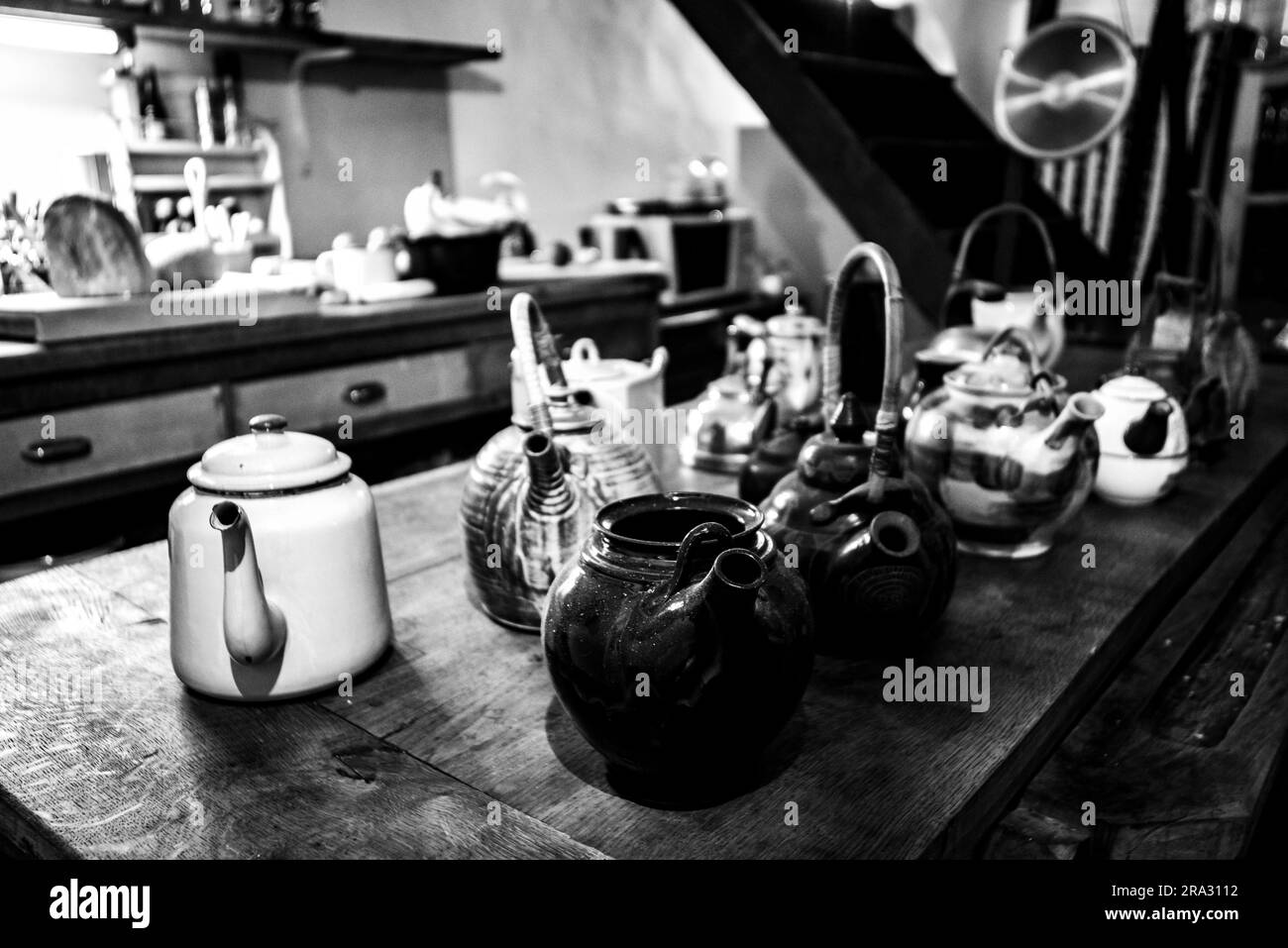 A grayscale shot of a traditional kitchen, with a variety of colorful ...