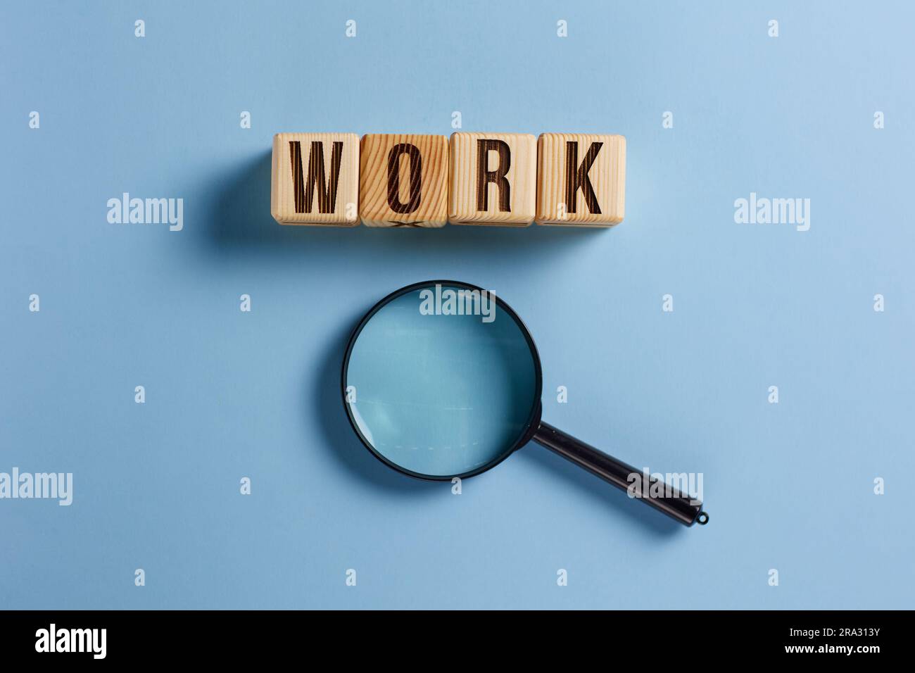 The word work is inscribed in wooden cubes. blue background Stock Photo ...
