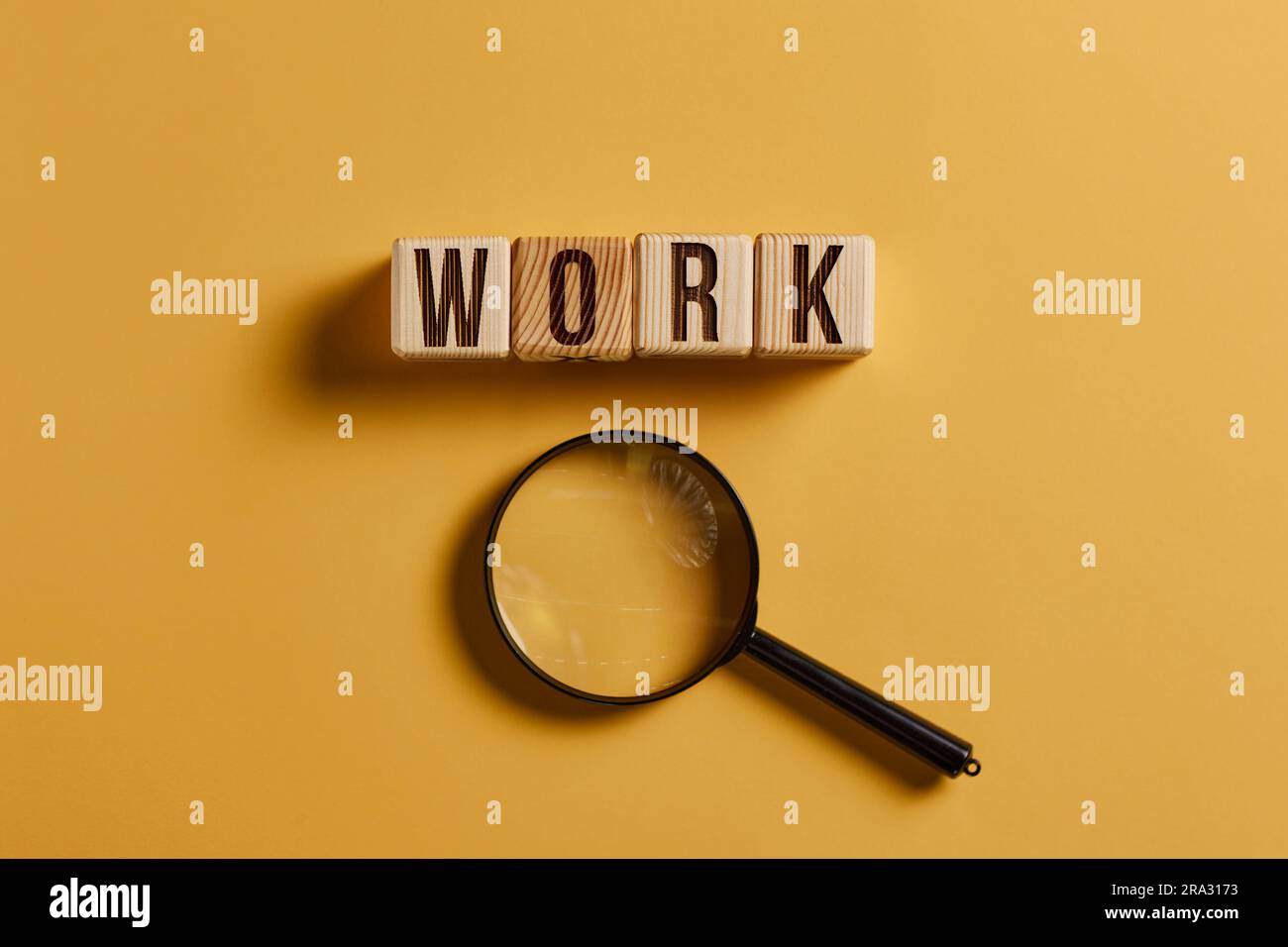 The word work is inscribed in wooden cubes. blue background Stock Photo ...
