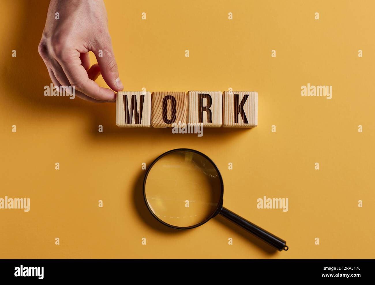 The word work is inscribed in wooden cubes. blue background Stock Photo ...