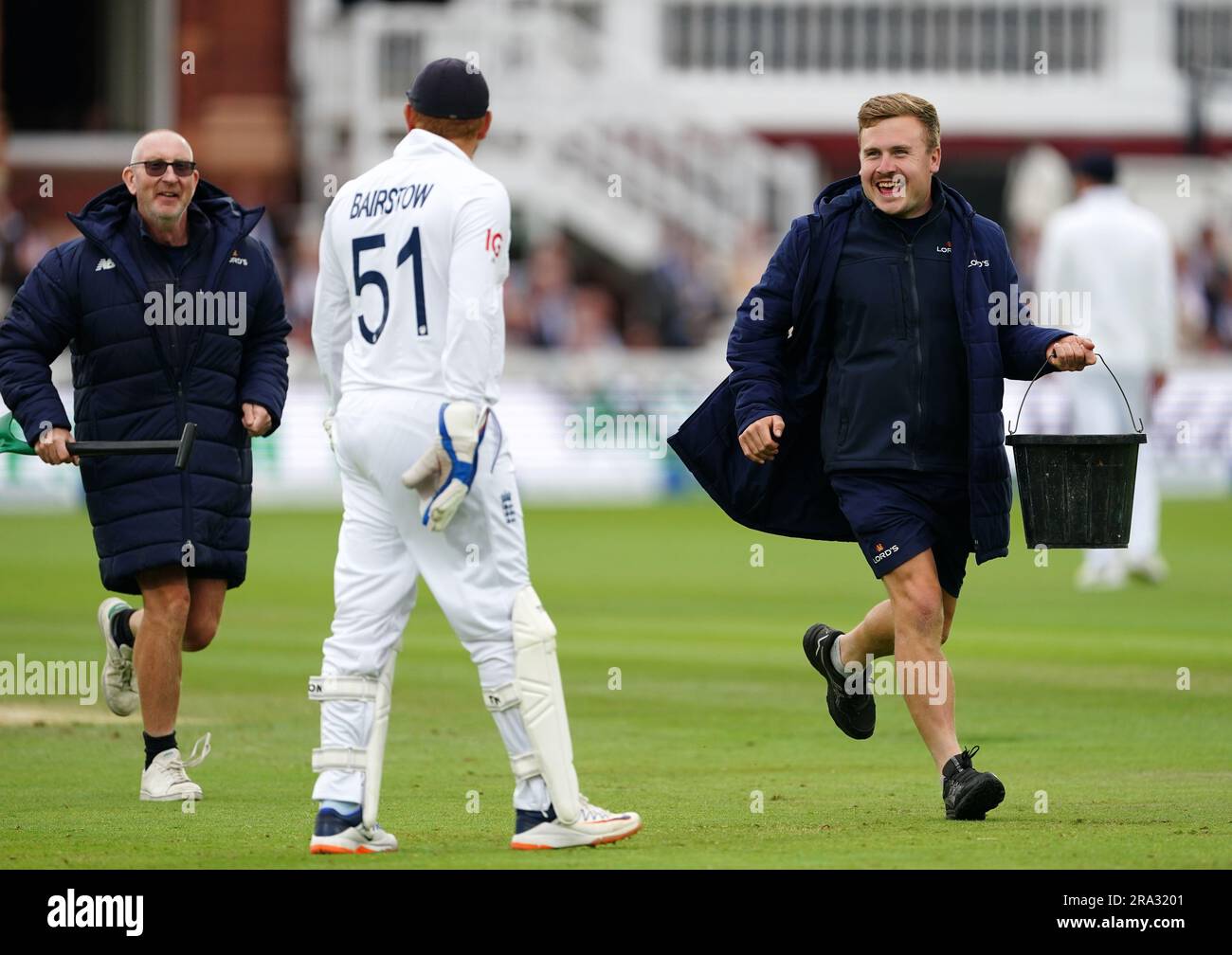 Ground staff share a joke with England's Jonny Bairstow after repairing ...