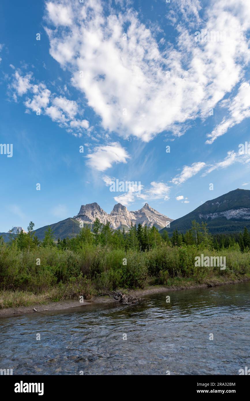 Three Sisters in Canmore seen at golden hour, sunset on blue sky day ...