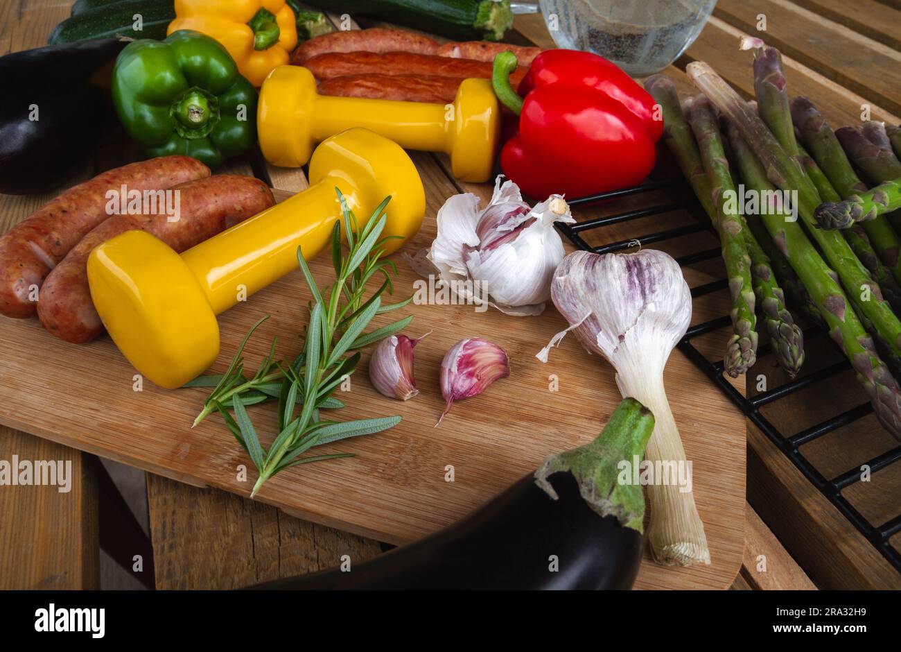 Gym dumbbells, vegetables, sausages for grill cooking. Fit barbecue ...