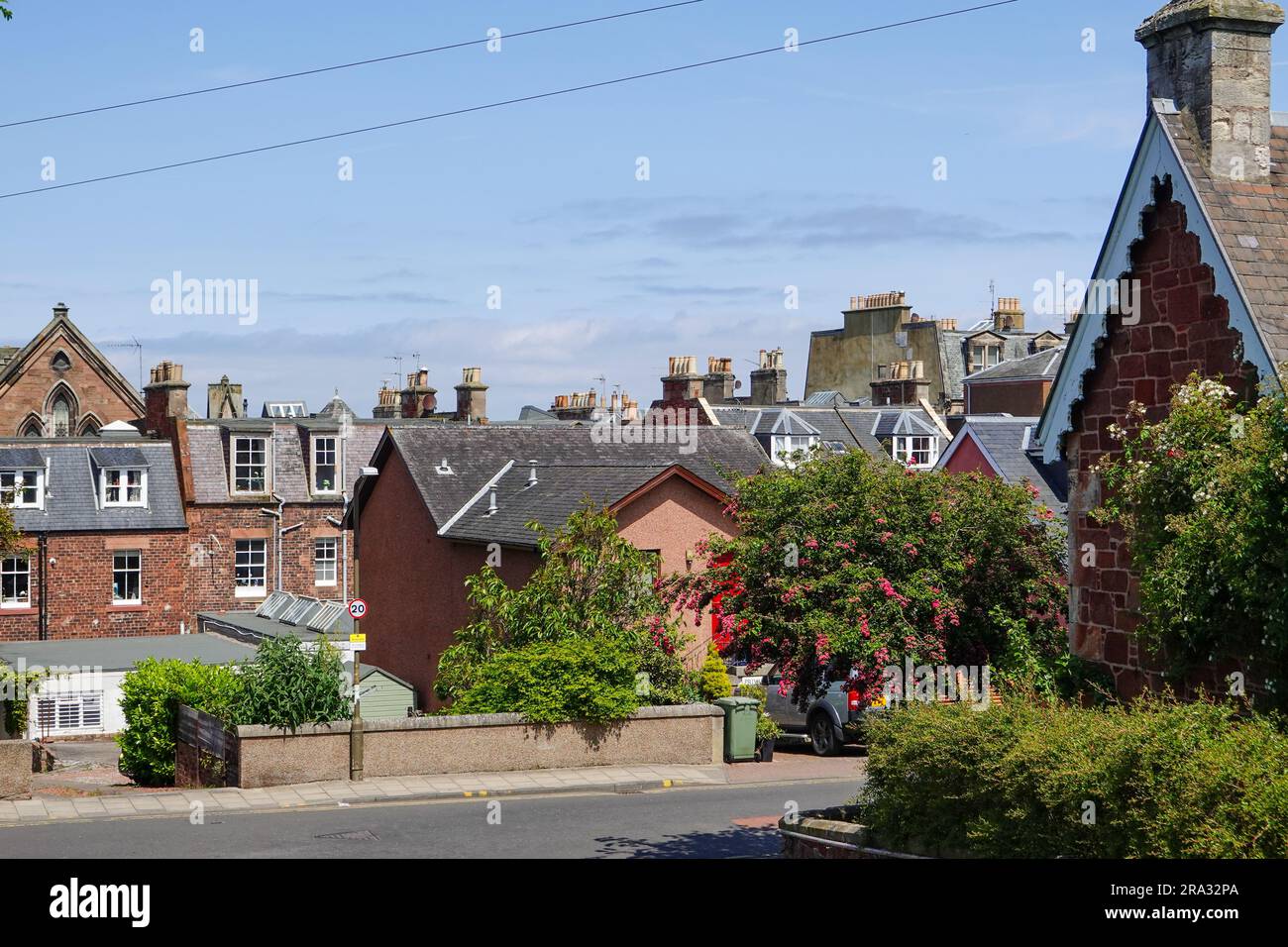 Looking over the gardens and rooftops of homes in the seaside town of ...