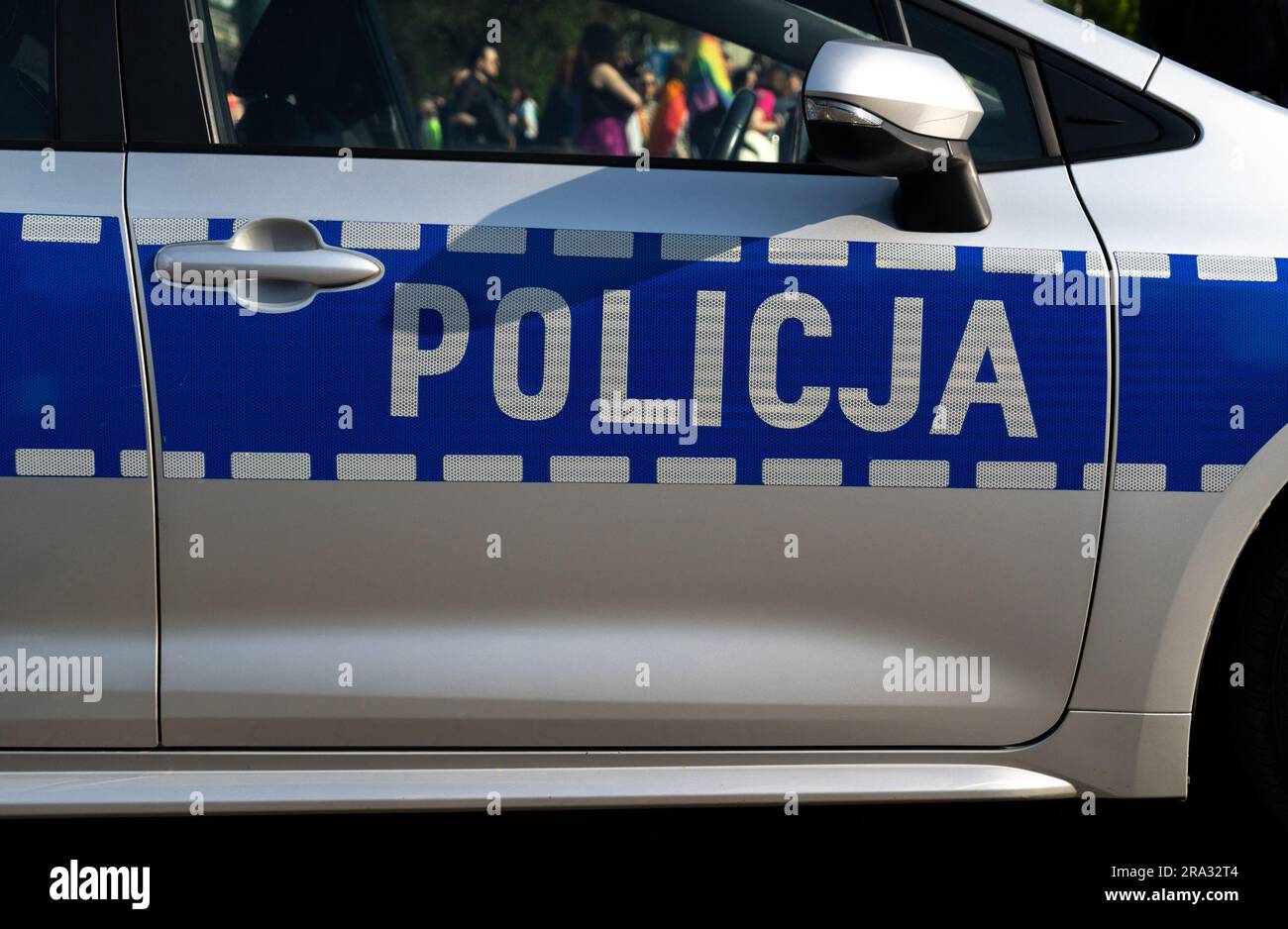 Police car side door sign in Poland. Letters in Polish language ...