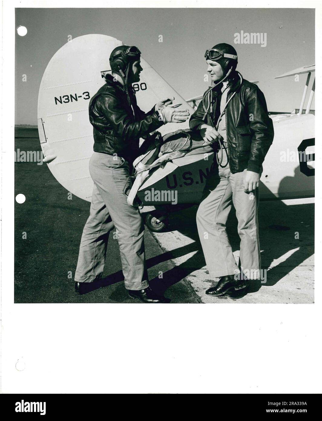 Photograph of Two Pilots Talking at Tail of Airplane Stock Photo - Alamy