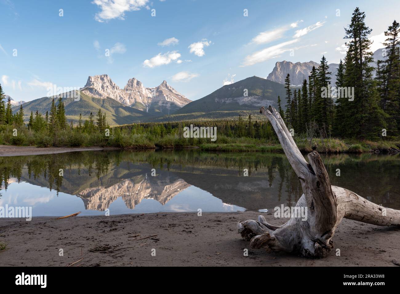 Three Sisters in Canmore seen at golden hour, sunset on blue sky day ...
