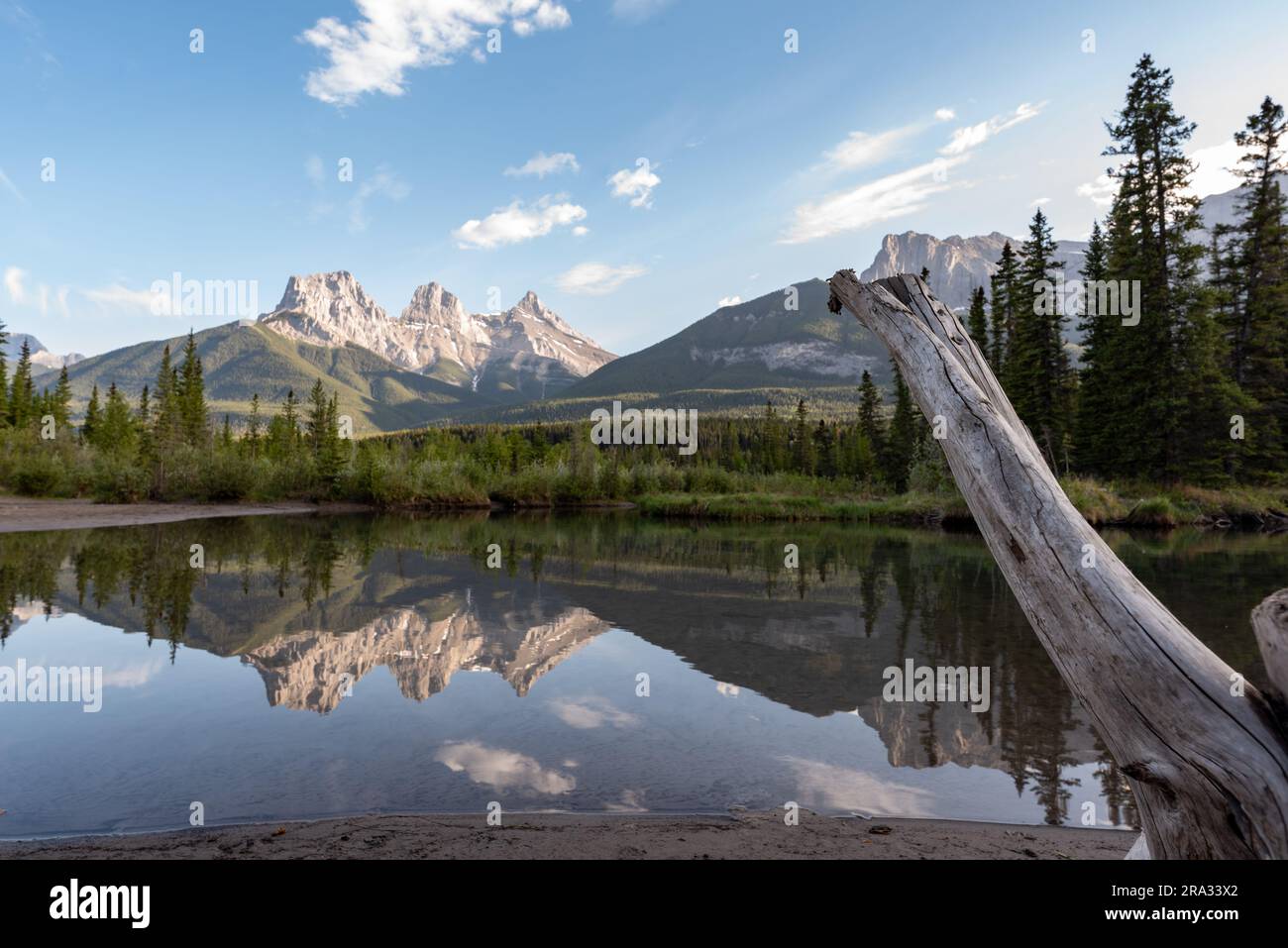Three Sisters in Canmore seen at golden hour, sunset on blue sky day ...