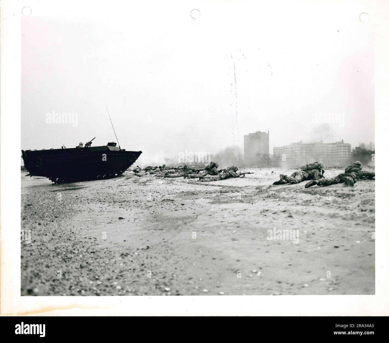 Photograph of Tank and Military Individuals Laying in Prone Position ...