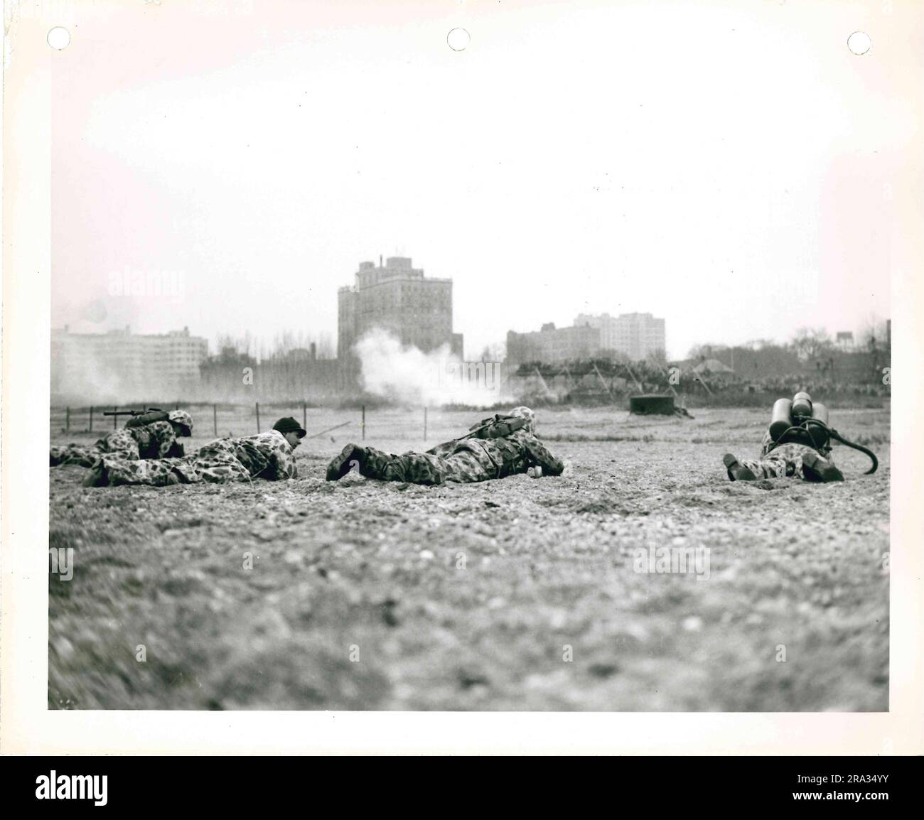 Photograph of Military Individuals Laying in Prone Position With One ...