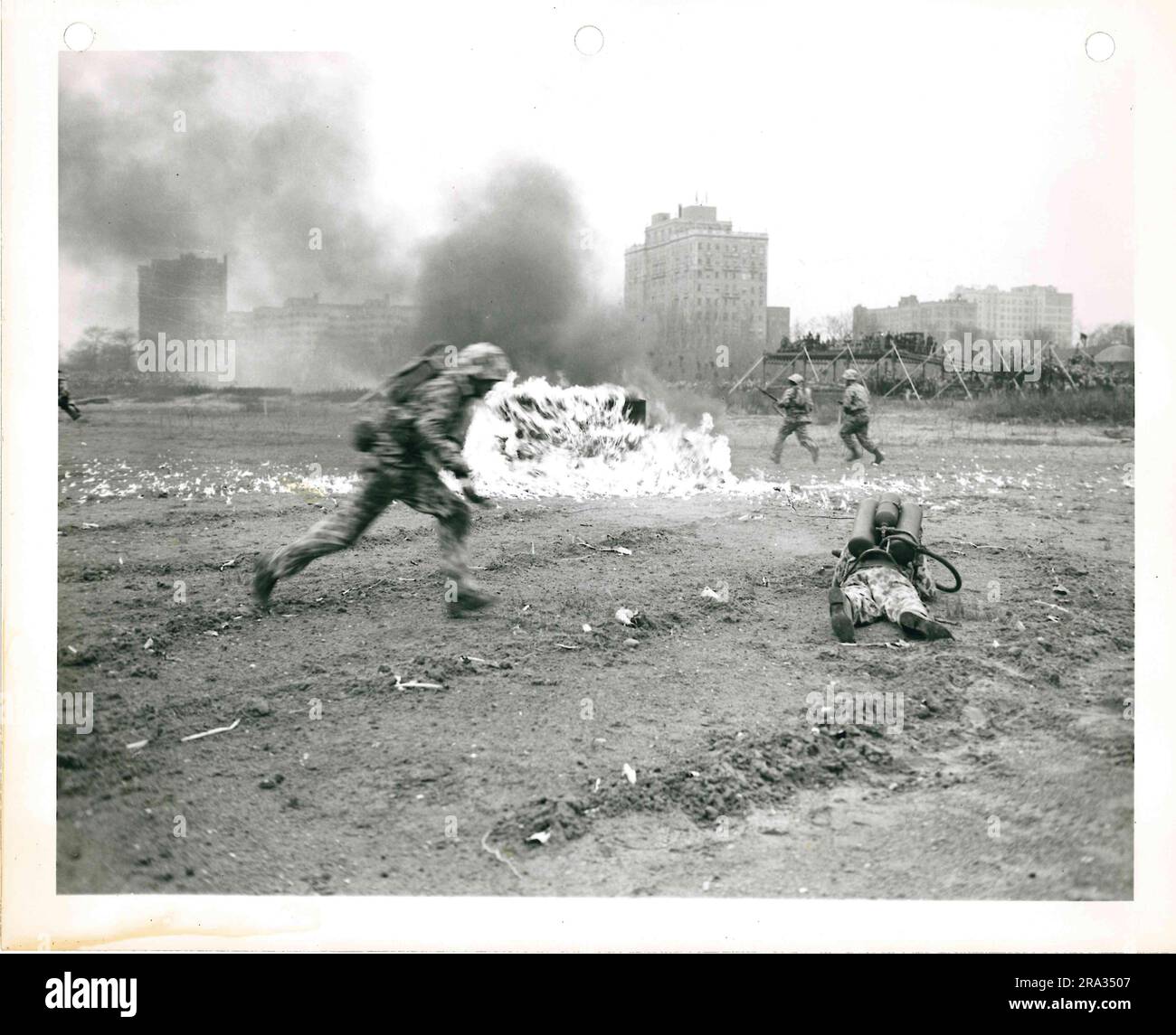 Photograph of Several Military Individuals Including One Using ...