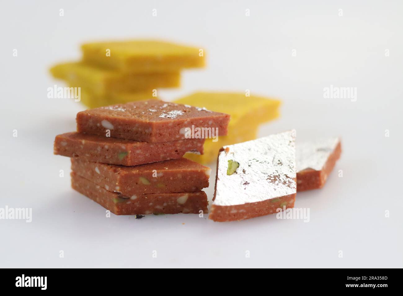 Badam burfi and kesar barfi. Two types of indian sweets in one frame ...