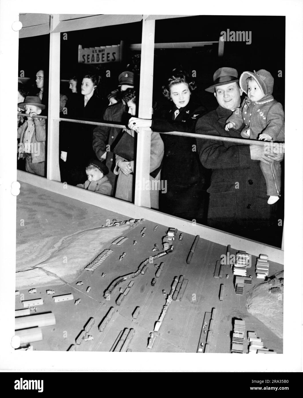 Photograph of Man and Baby Looking at Unknown Model Display Stock Photo ...