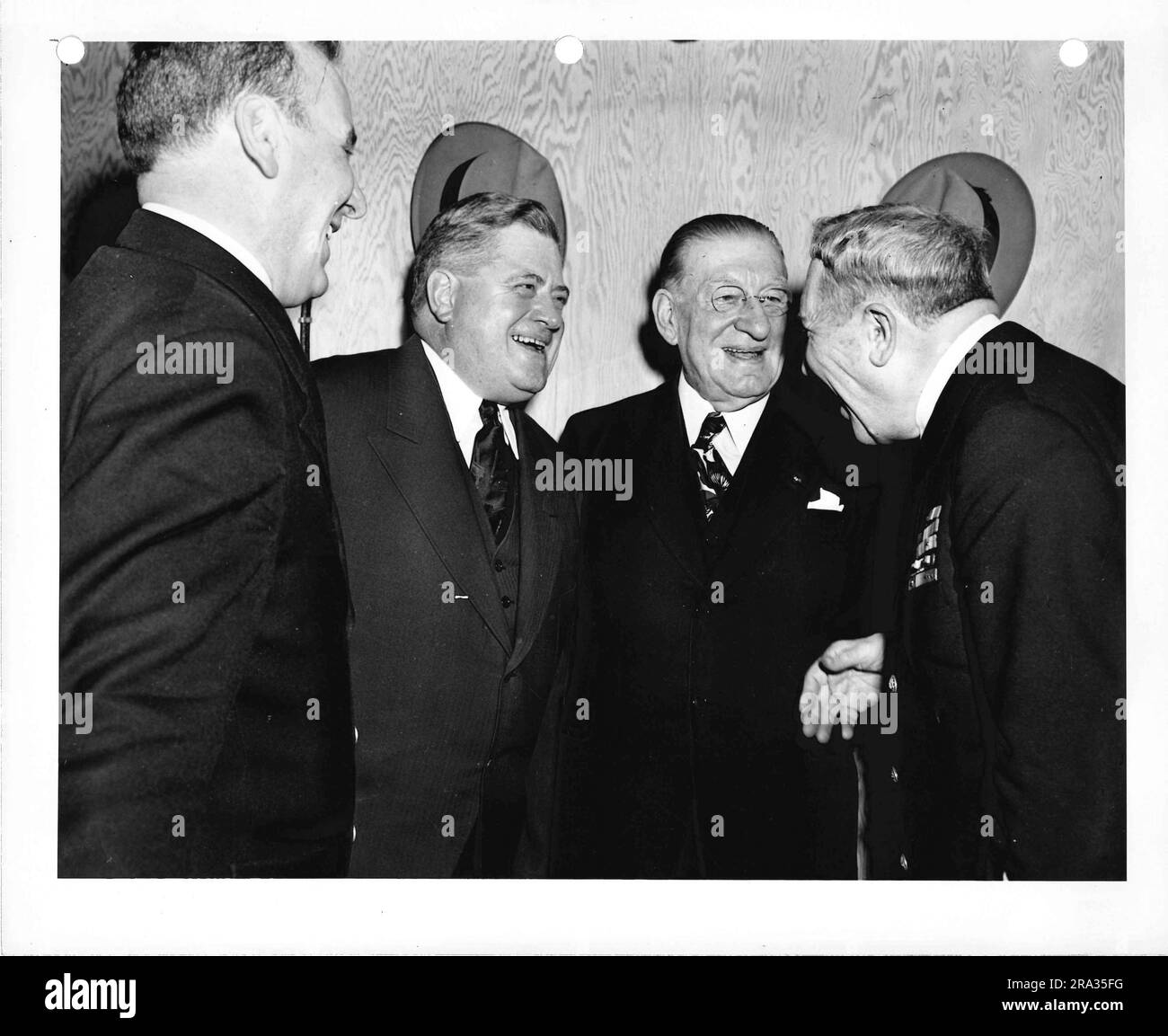 Four men sitting Black and White Stock Photos & Images - Alamy
