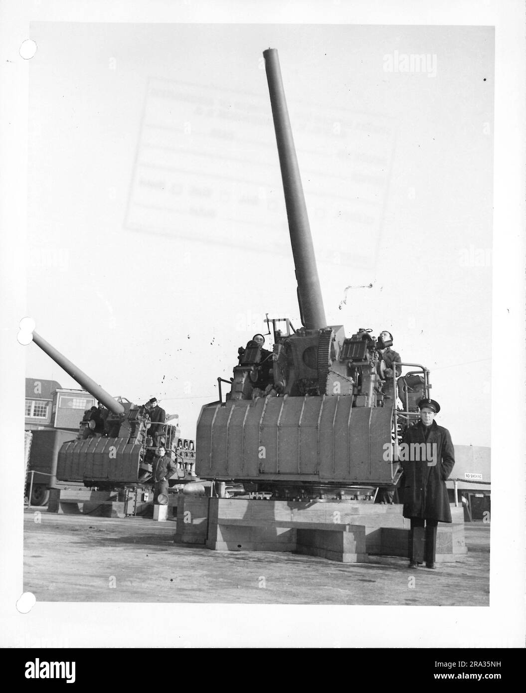 Photograph of Military Individual Standing Near Manned Turret Guns ...