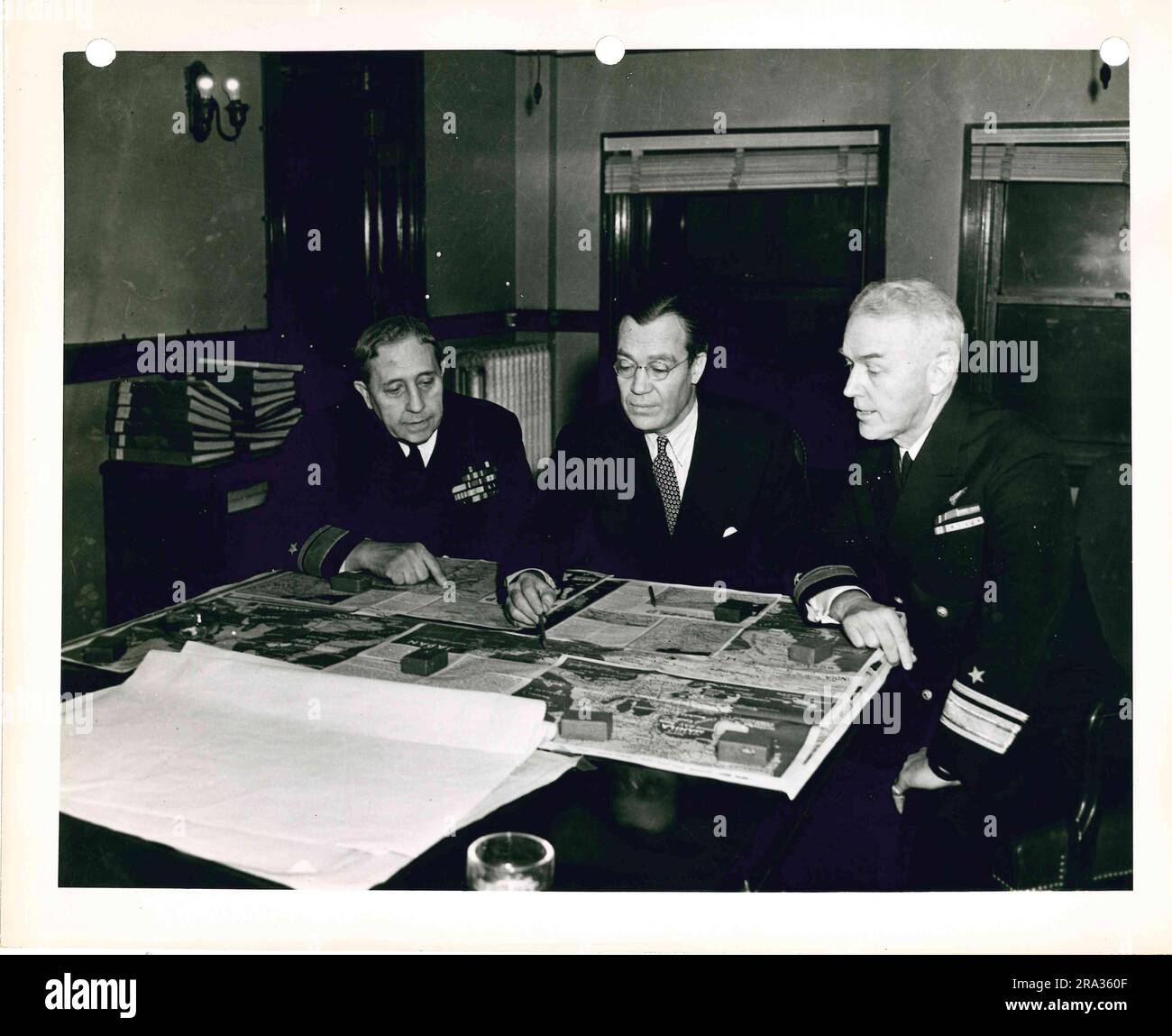 Photograph of Three Men (Two in Military Uniform) Looking at Maps of ...