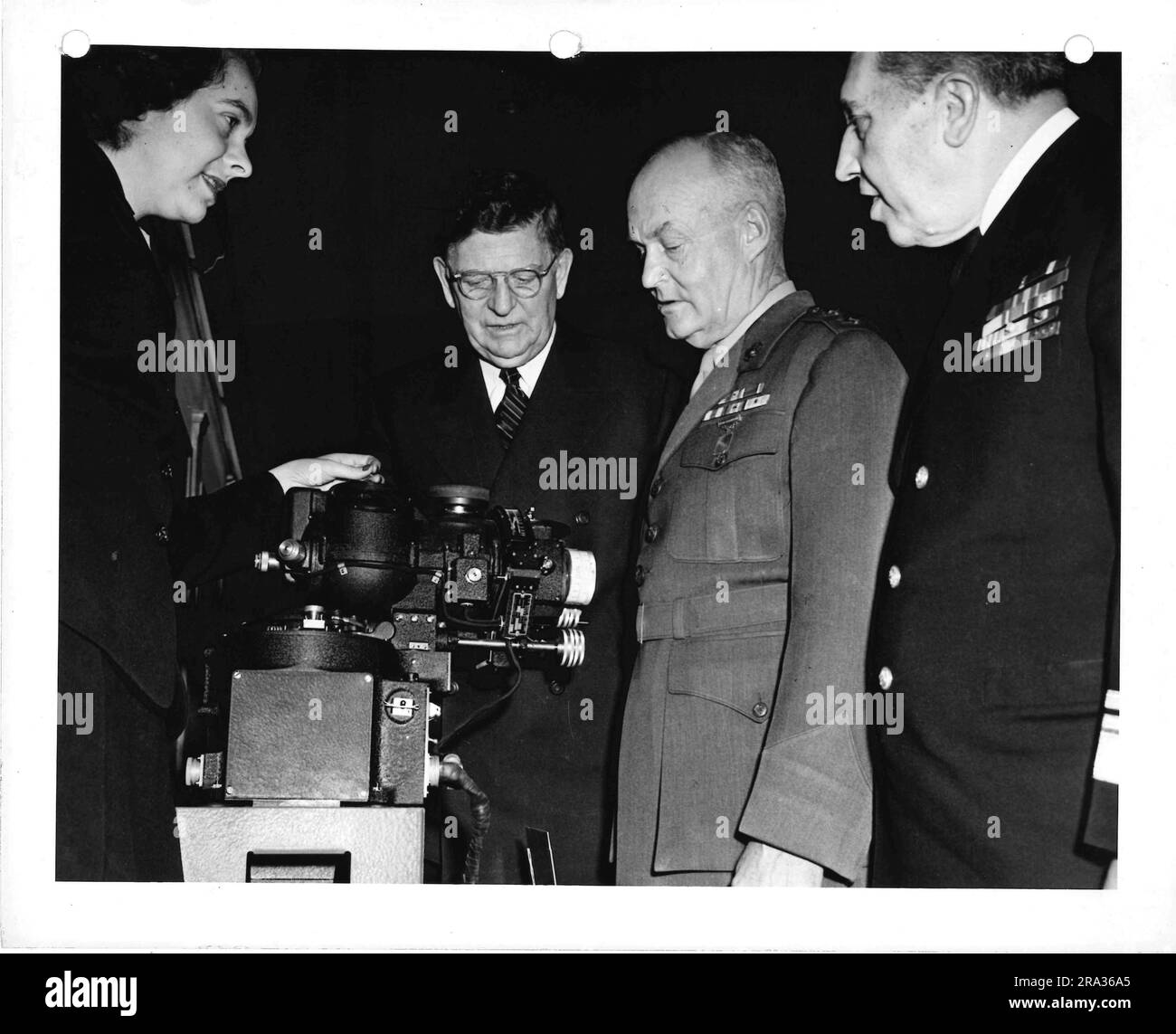 Photograph of Woman Showing Technical Instrument to Members of the ...