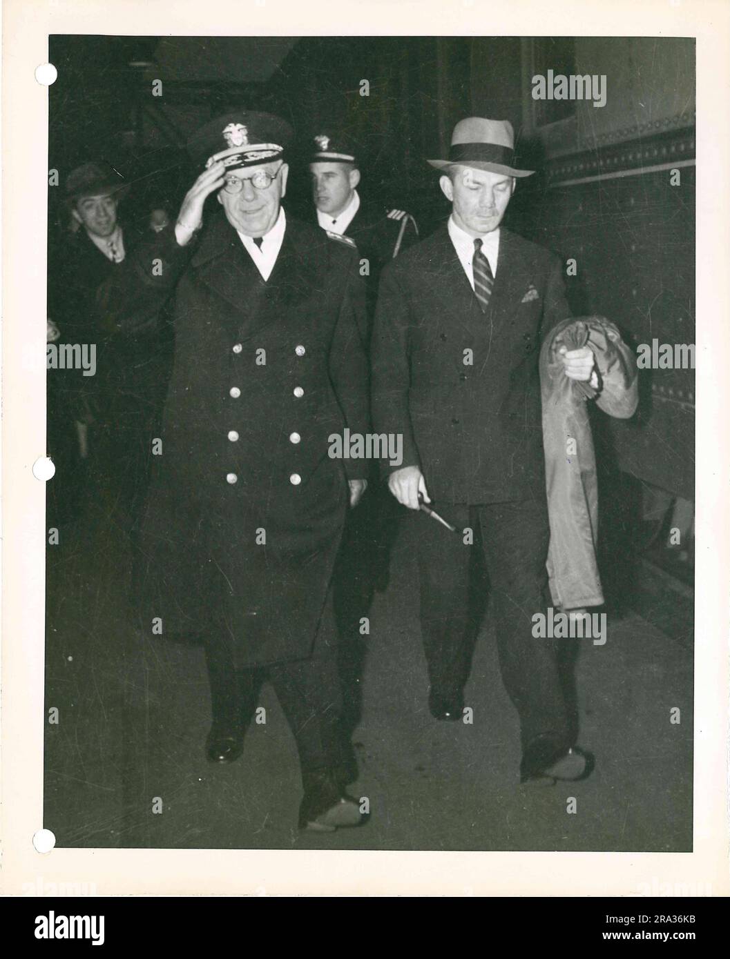 Photograph of Man in Military Uniform Saluting While Walking with Man ...
