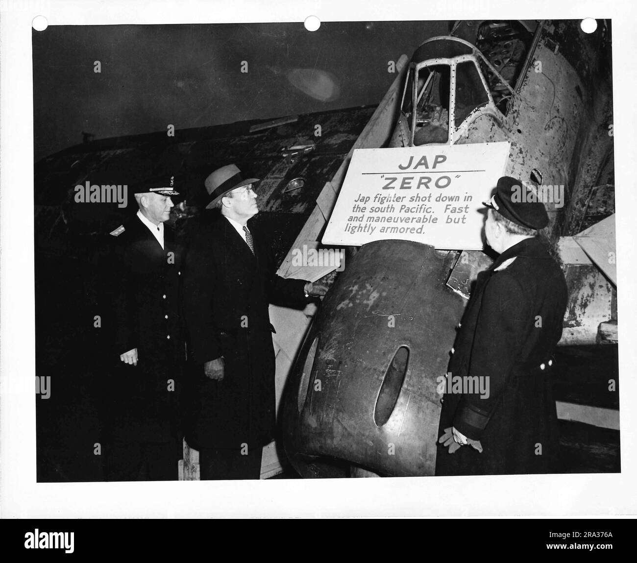Photograph of Three Men Looking at a Japanese "Zero" Airplane Stock ...