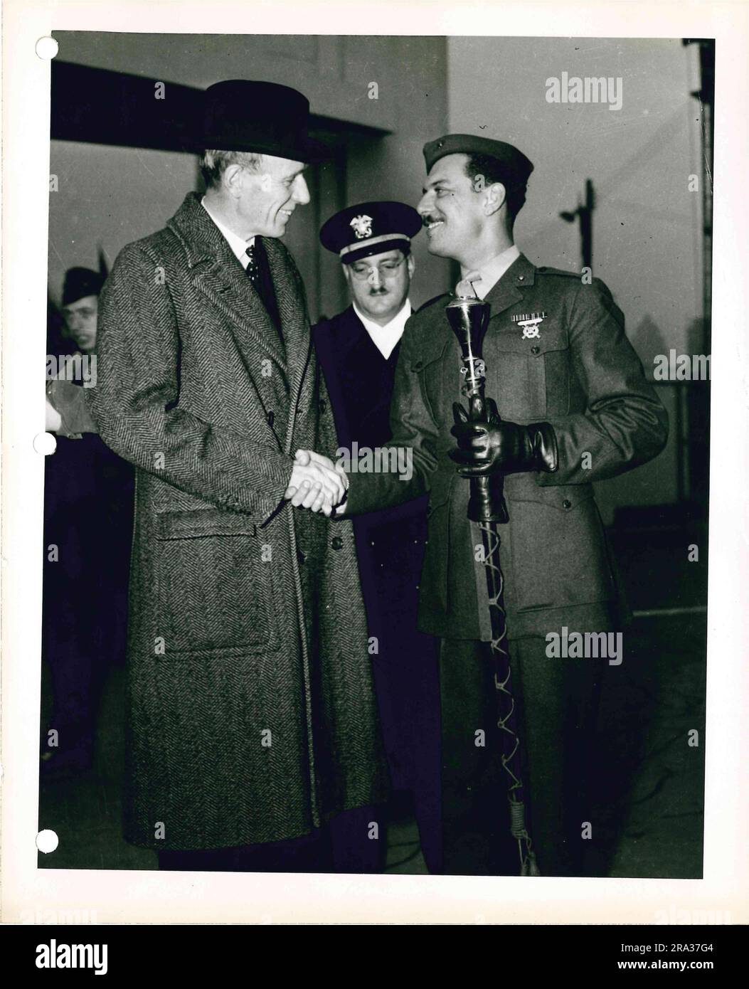 Photograph of Two Men Shaking Hands (One in Military Uniform Holding ...