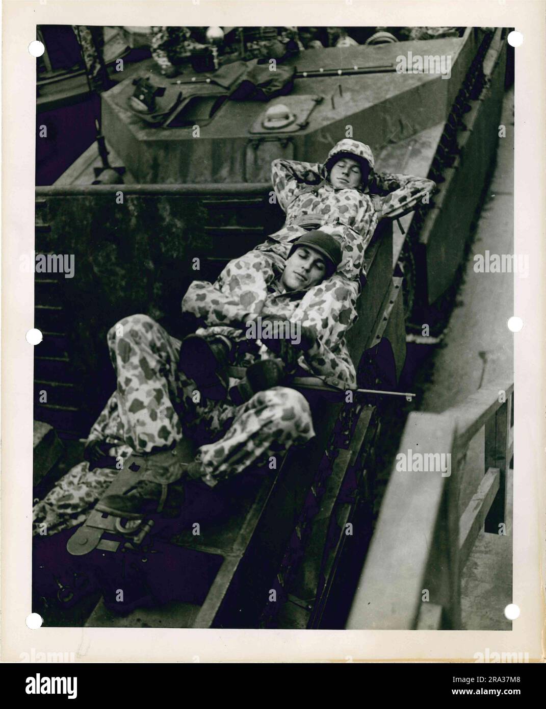 Photograph of Military Individuals Resting on Tank Stock Photo - Alamy