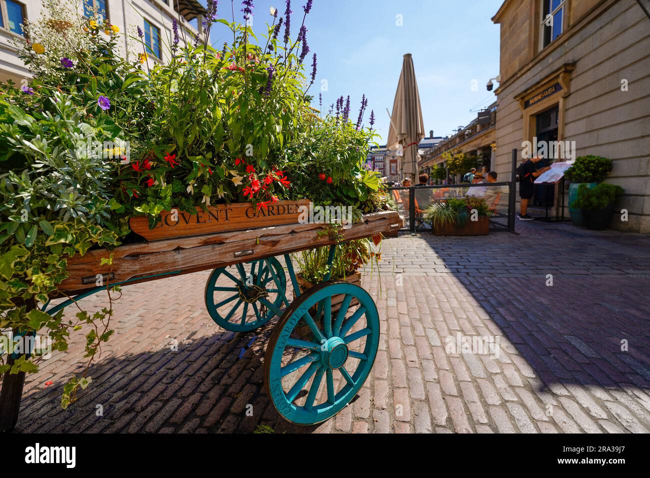 Covent Garden Market sign in an antique wooden cart, surrounded by ...