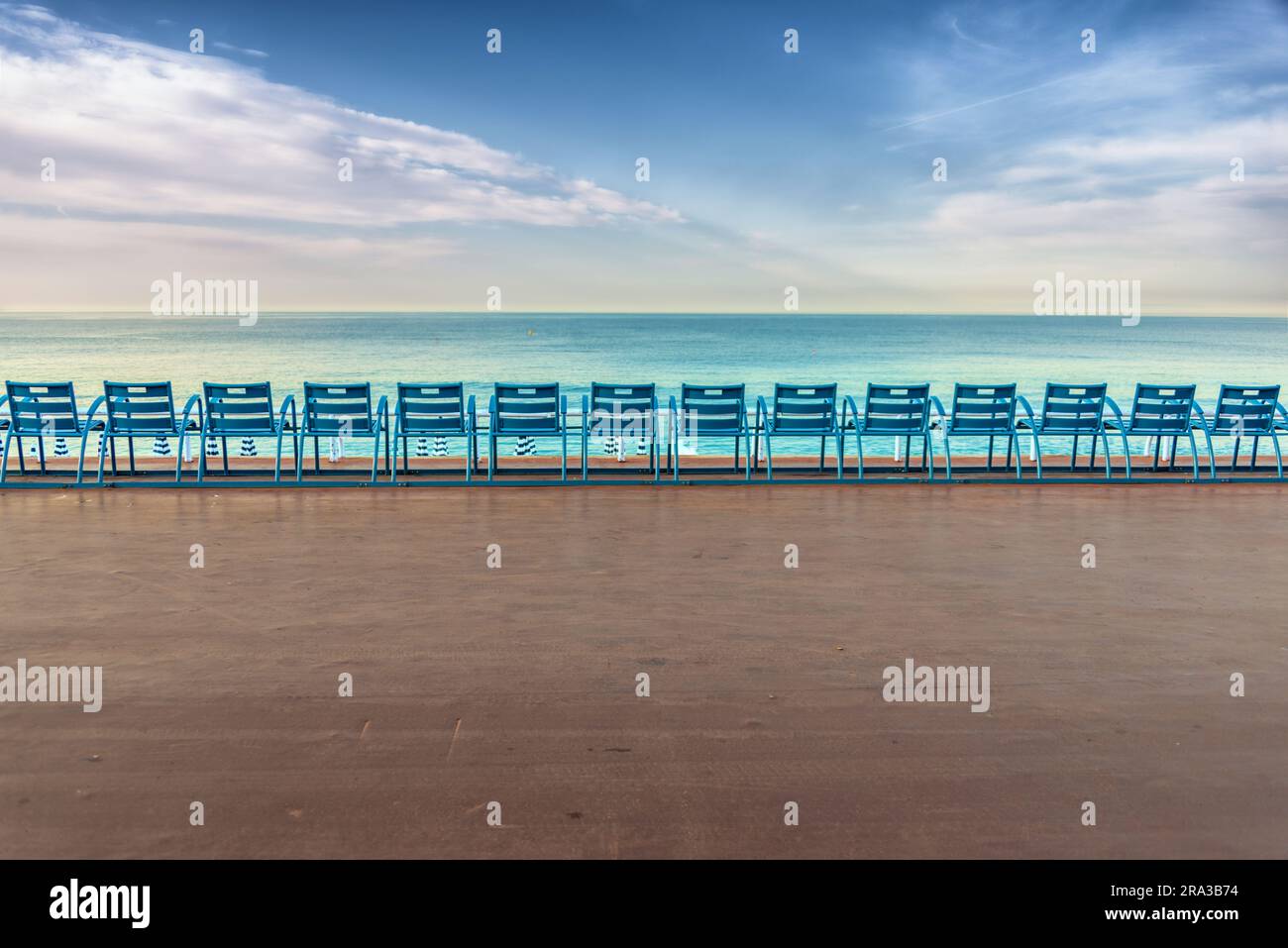 Seaside boardwalk, promenade with row of beach chairs overlooking the ...