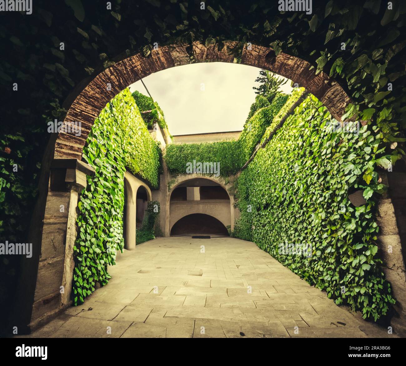 An ornate, red-brick archway is the entrance to a building, with lush ...