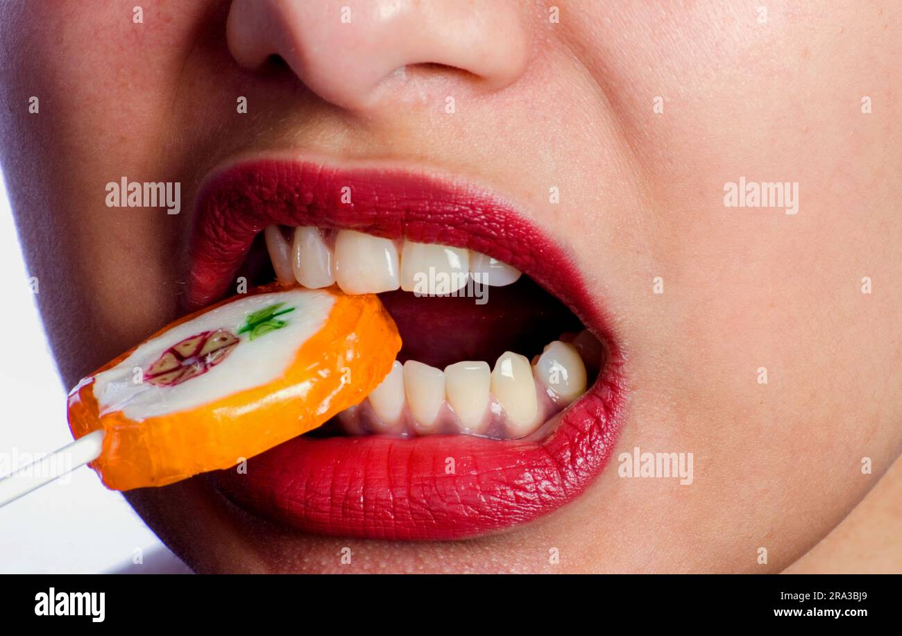 Beautiful Woman Biting Lollipop Stock Photo - Alamy