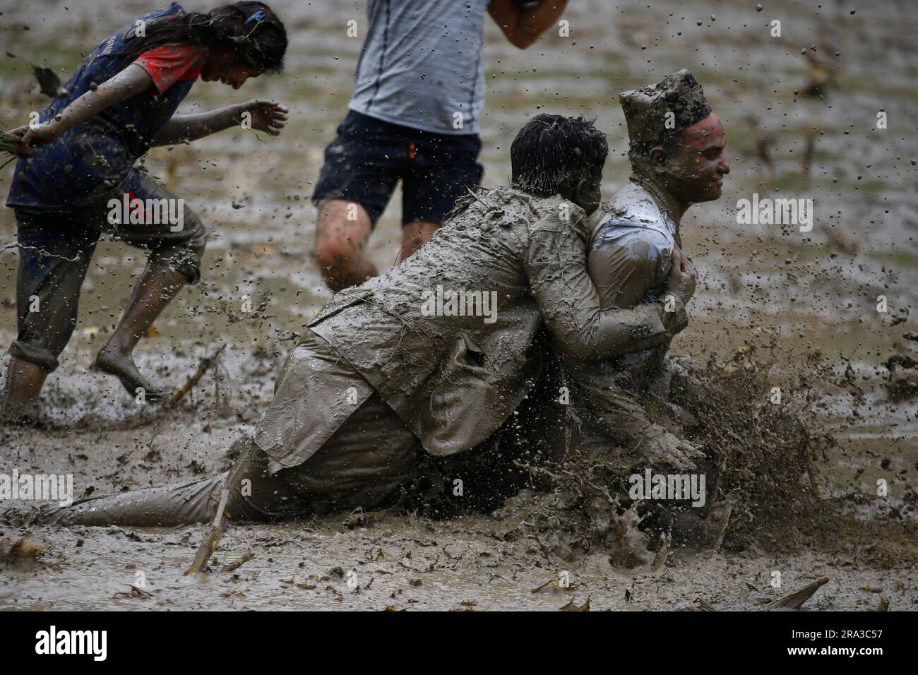 Nuwakot, Nepal. 30th June, 2023. Farmers joyfully play as they plant ...