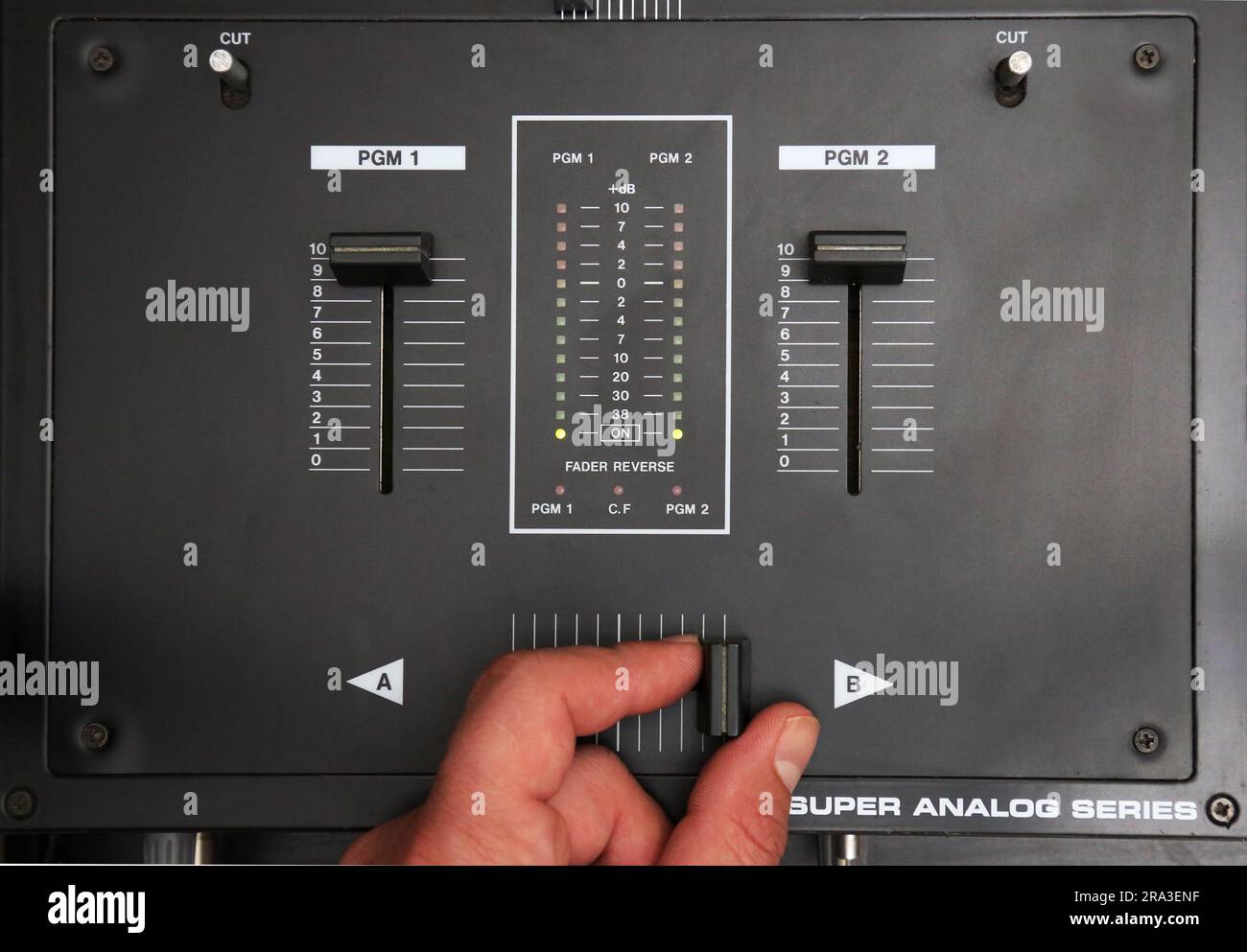 DJ mixer close up with hand (super analog with crossfader) volume knobs ...