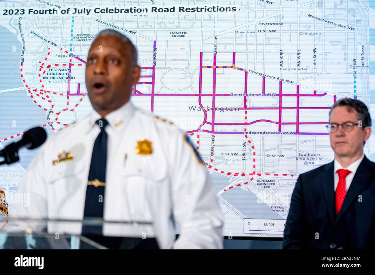 A city map of road restrictions is displayed behind Washington ...