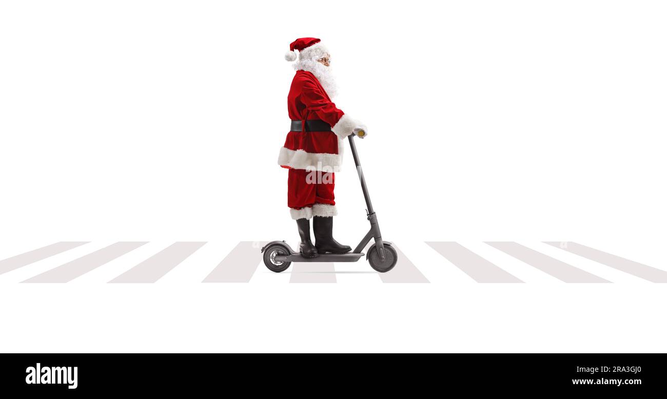 Full length profile shot of Santa Claus riding an electric scooter at a ...