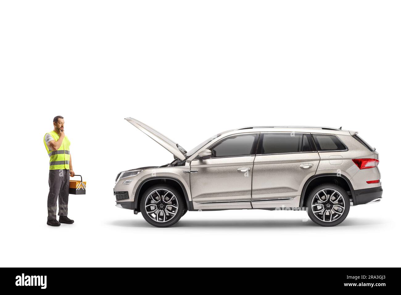 Roadside car mechanic holding a tool box and looking at a SUV with an ...